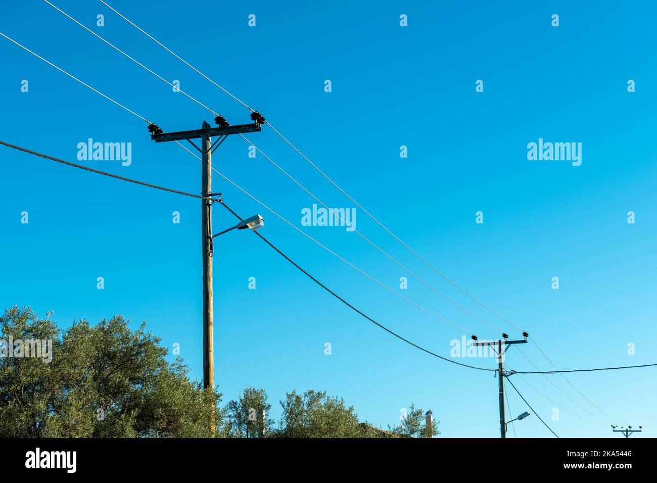 Overhead electricity cable on wooden posts bringing the electricity ...