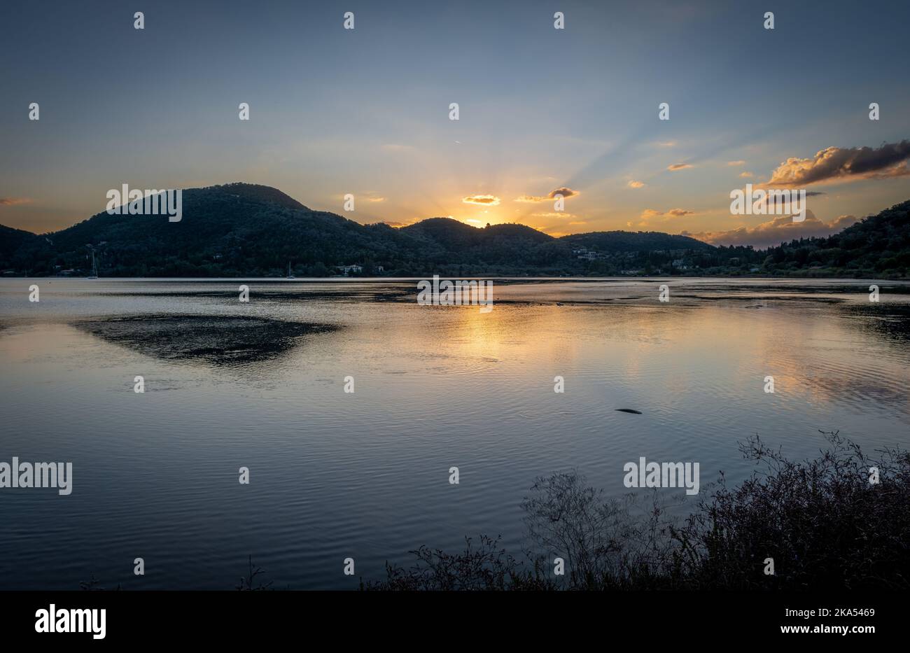 The sun rising the hills over Geni Bay, Lefkada island, Greece with the ...