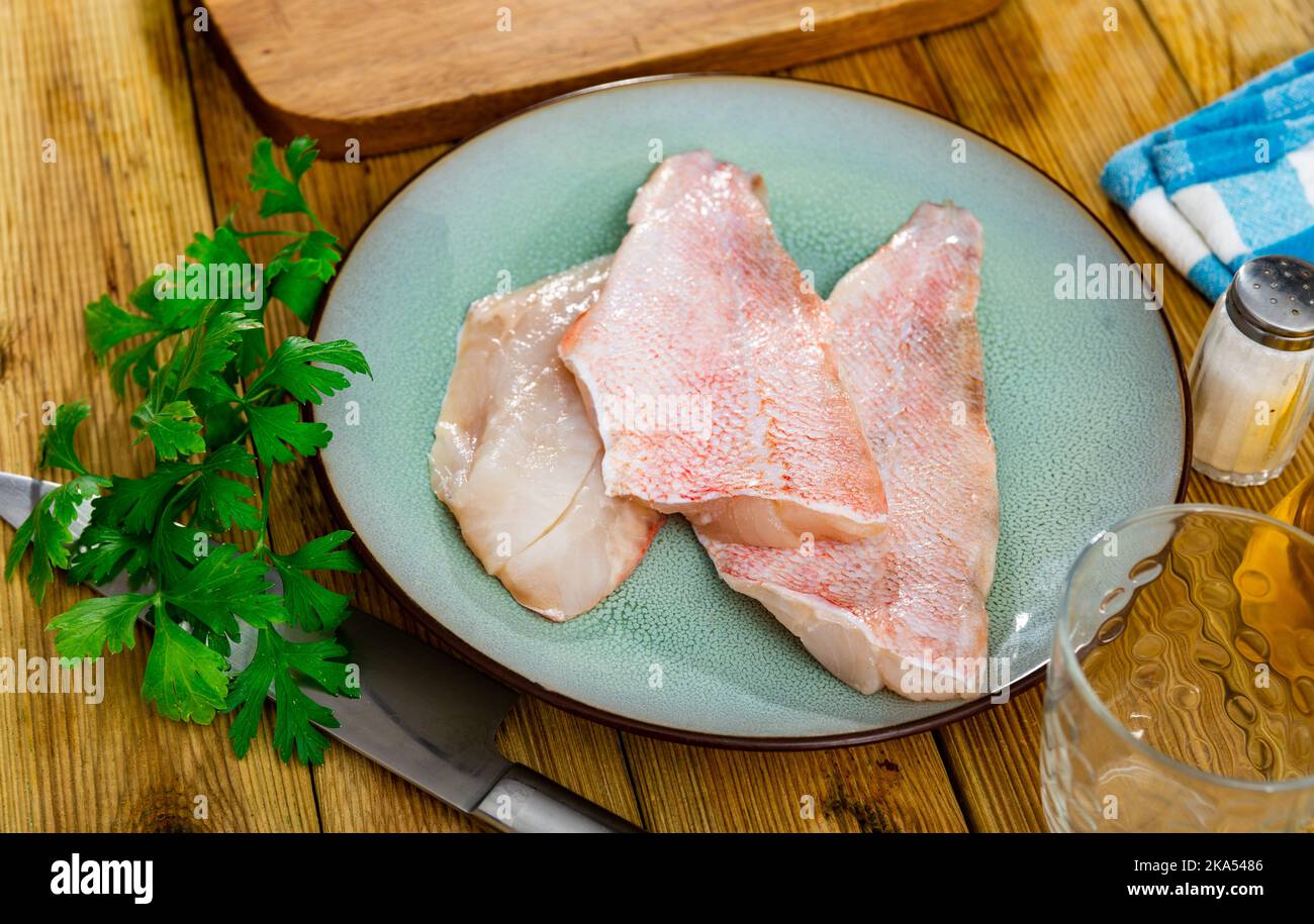 Raw rockfish fillet with condiments, cooking ingredients Stock Photo ...