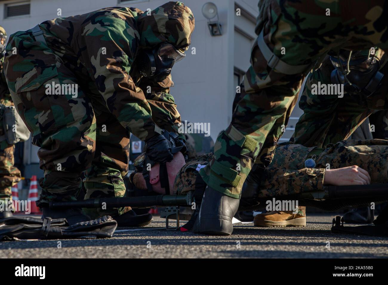 U.S. Navy Hospital Corpsmen with Marine Aircraft Group (MAG) 12 removes ...