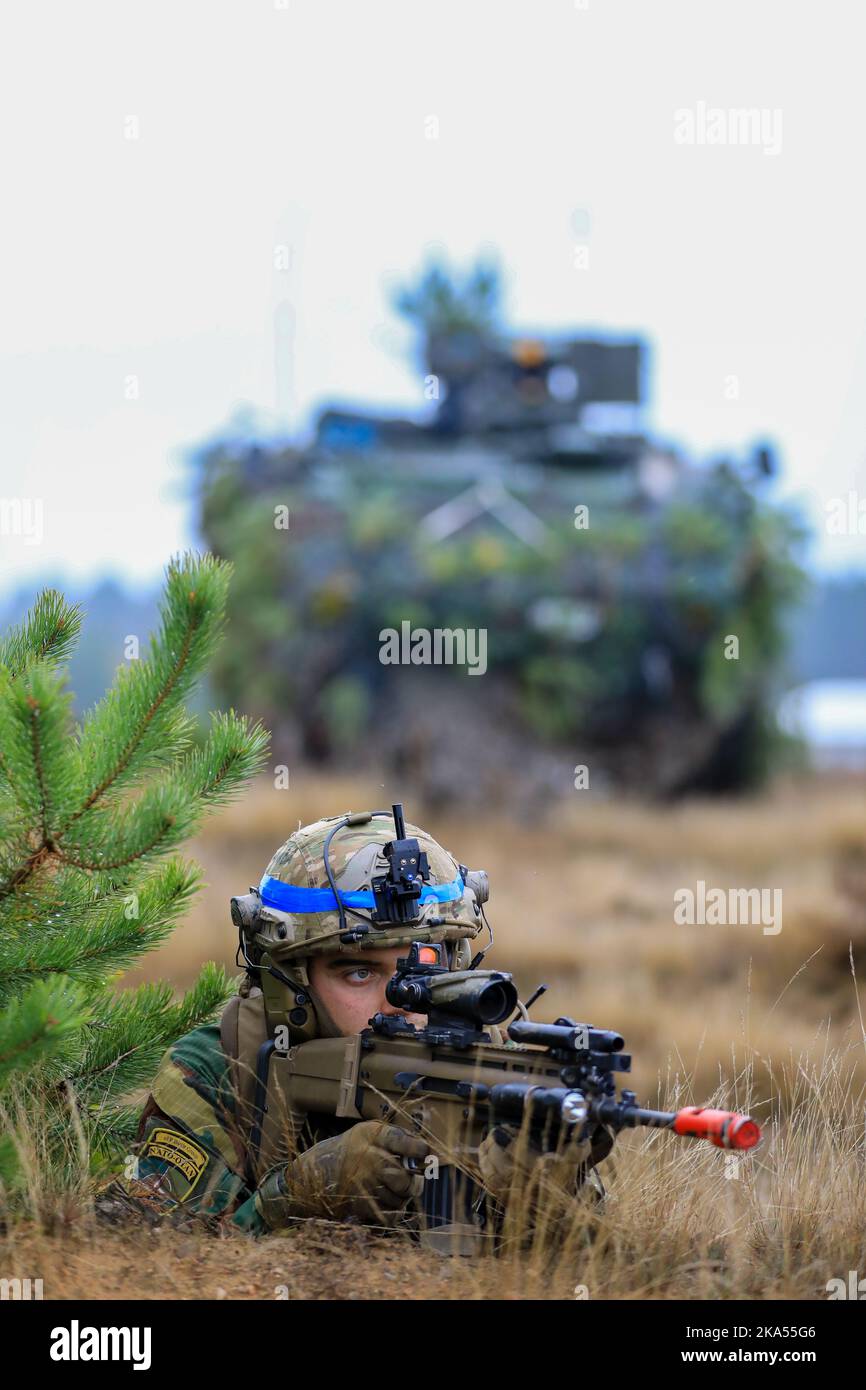 A Belgium Armed Forces soldier conducts a security halt during a ...