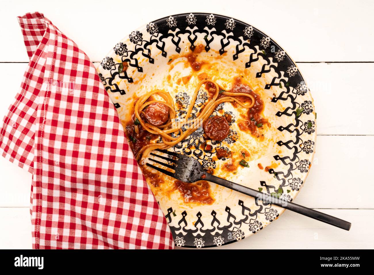 Top view of a plate of Italian spaghetti with sausage and tomato sauce ...