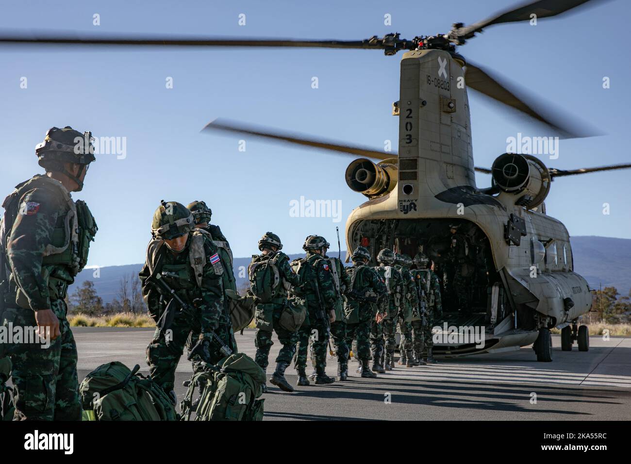 Royal Thai Armed Forces line up to move equipment off a CH-47 Chinook helicopter assigned to 3rd ...