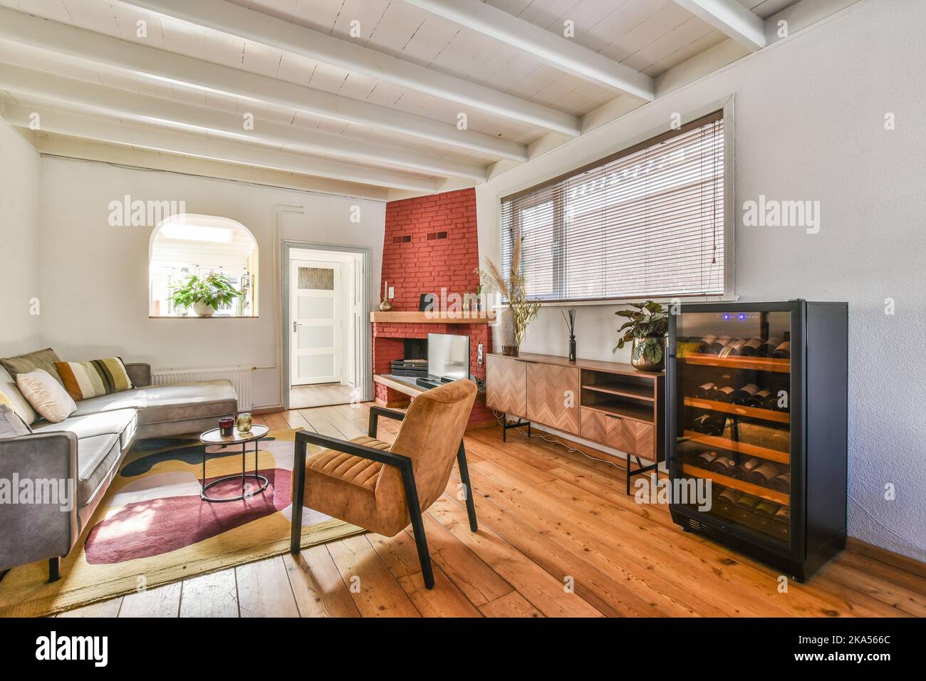 Table with chairs and flowers located near lounge area and kitchen in ...