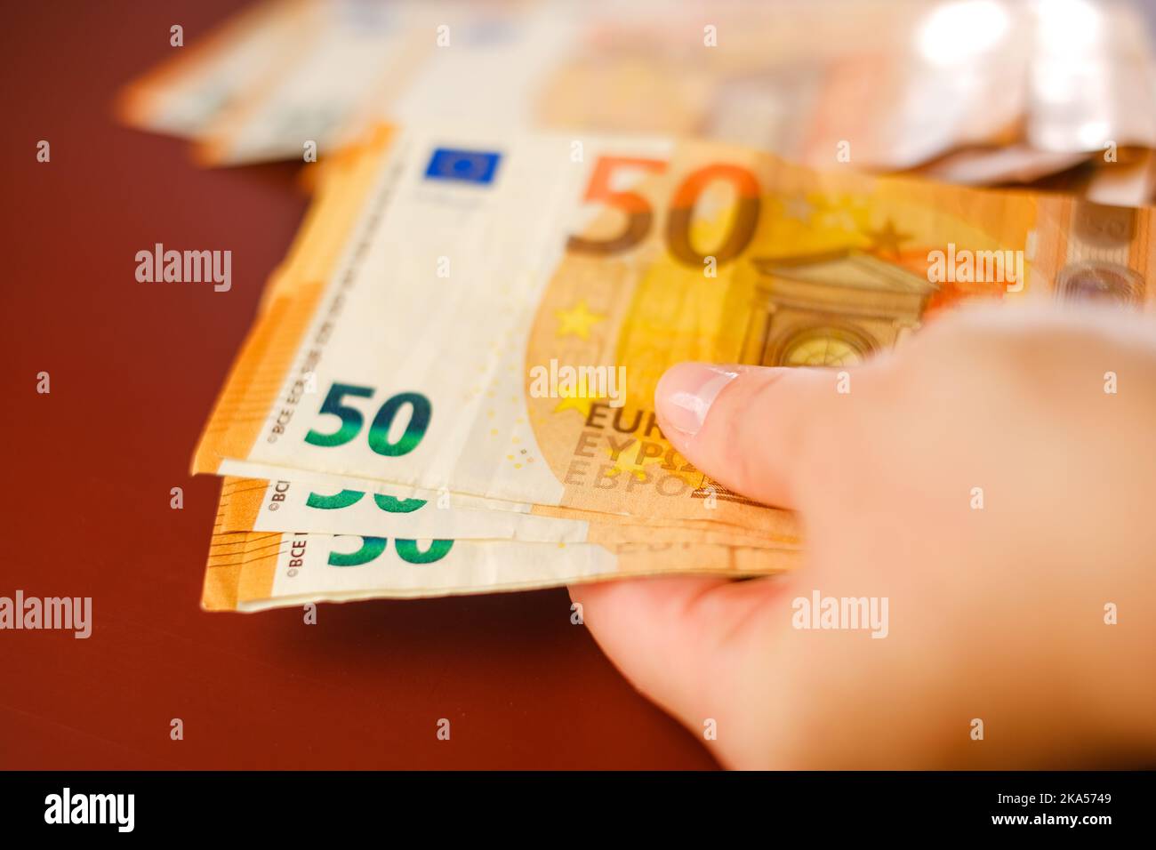 50 euro banknotes in hand . Expenses and incomes in European countries ...