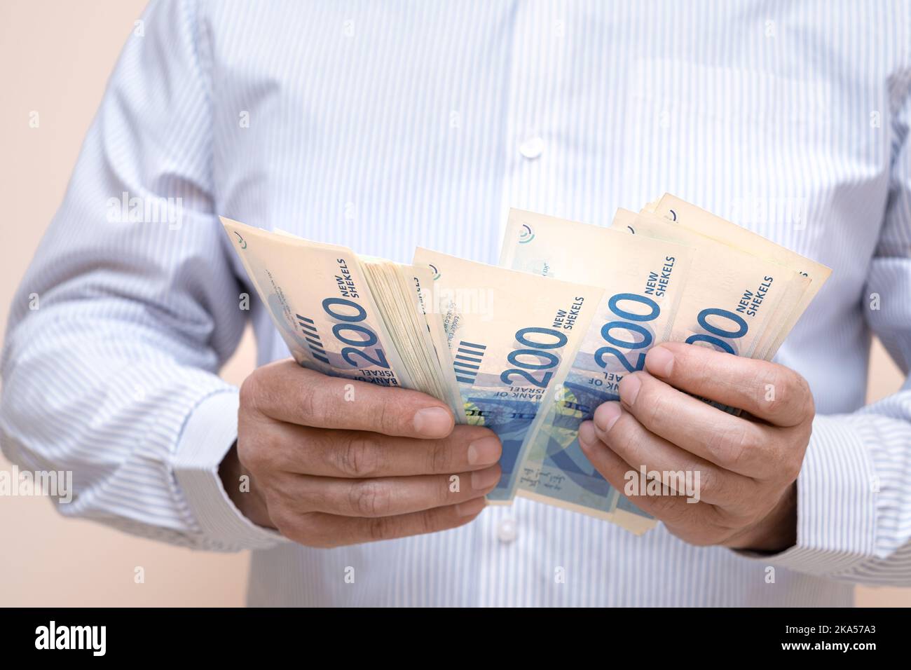 New Israeli shekels banknotes with the new 200 nis. Men hold shekels on ...