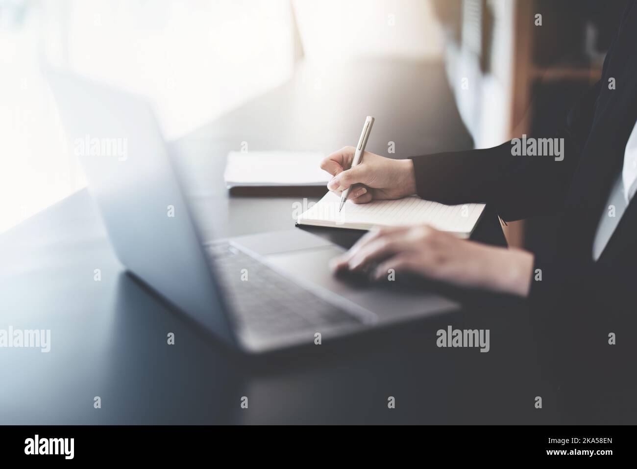 usiness woman writing marketing plan in notebook ready to use computer ...