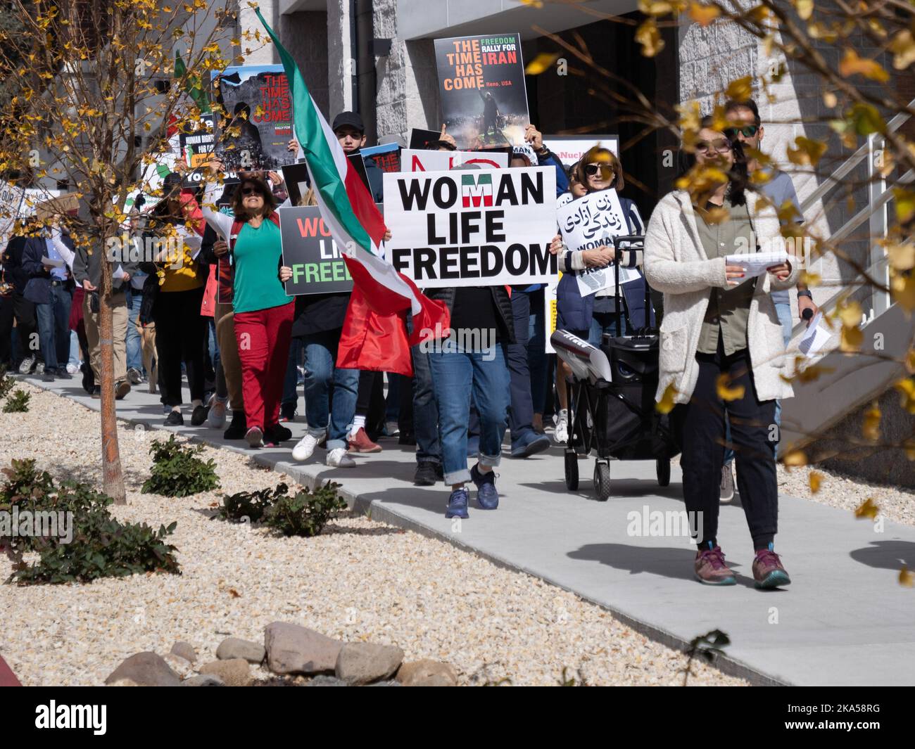 Reno, United States. 22nd Oct, 2022. Protesters hold placards, flags ...