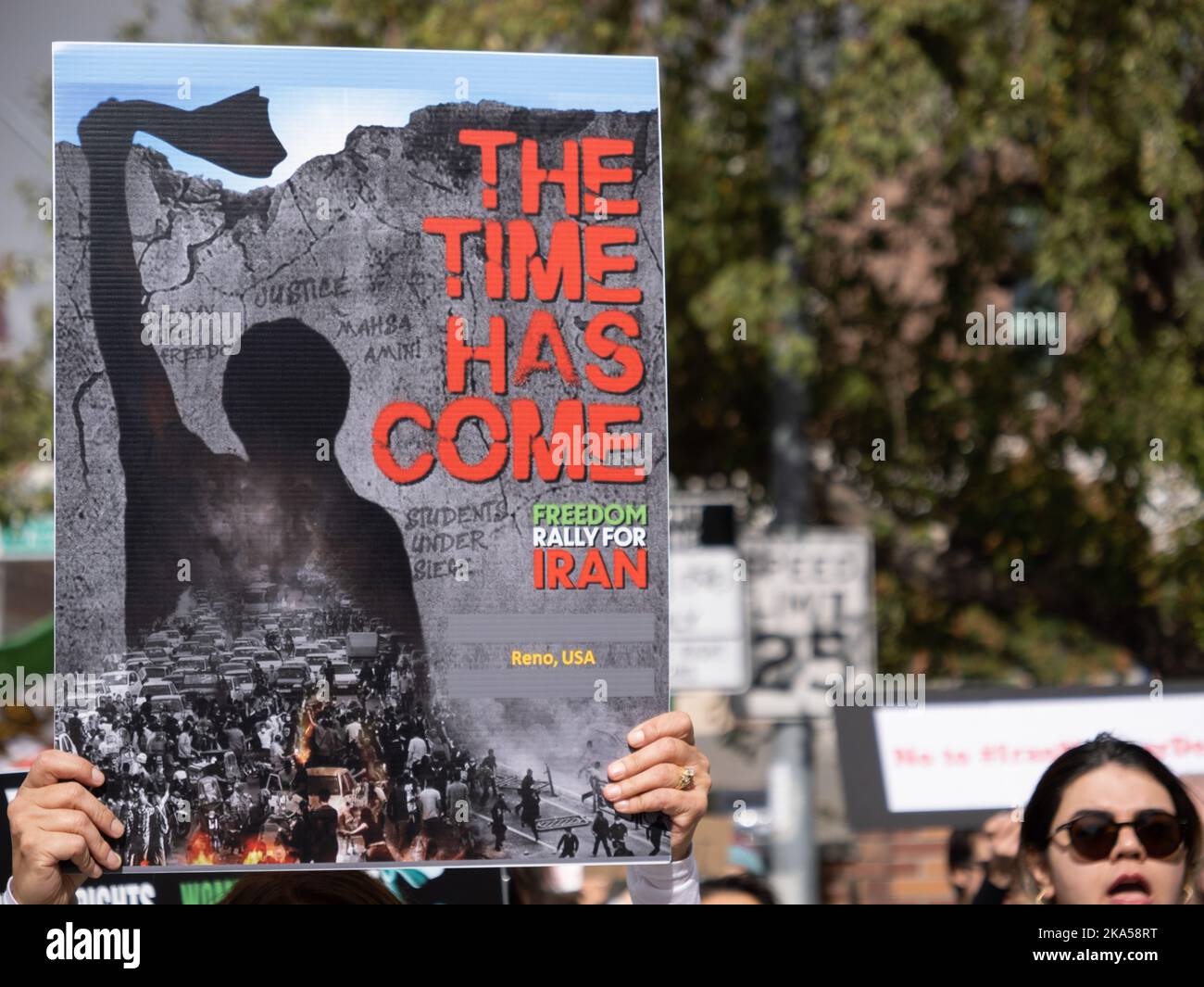 A protester holds a placard that says "the time has come, freedom rally ...