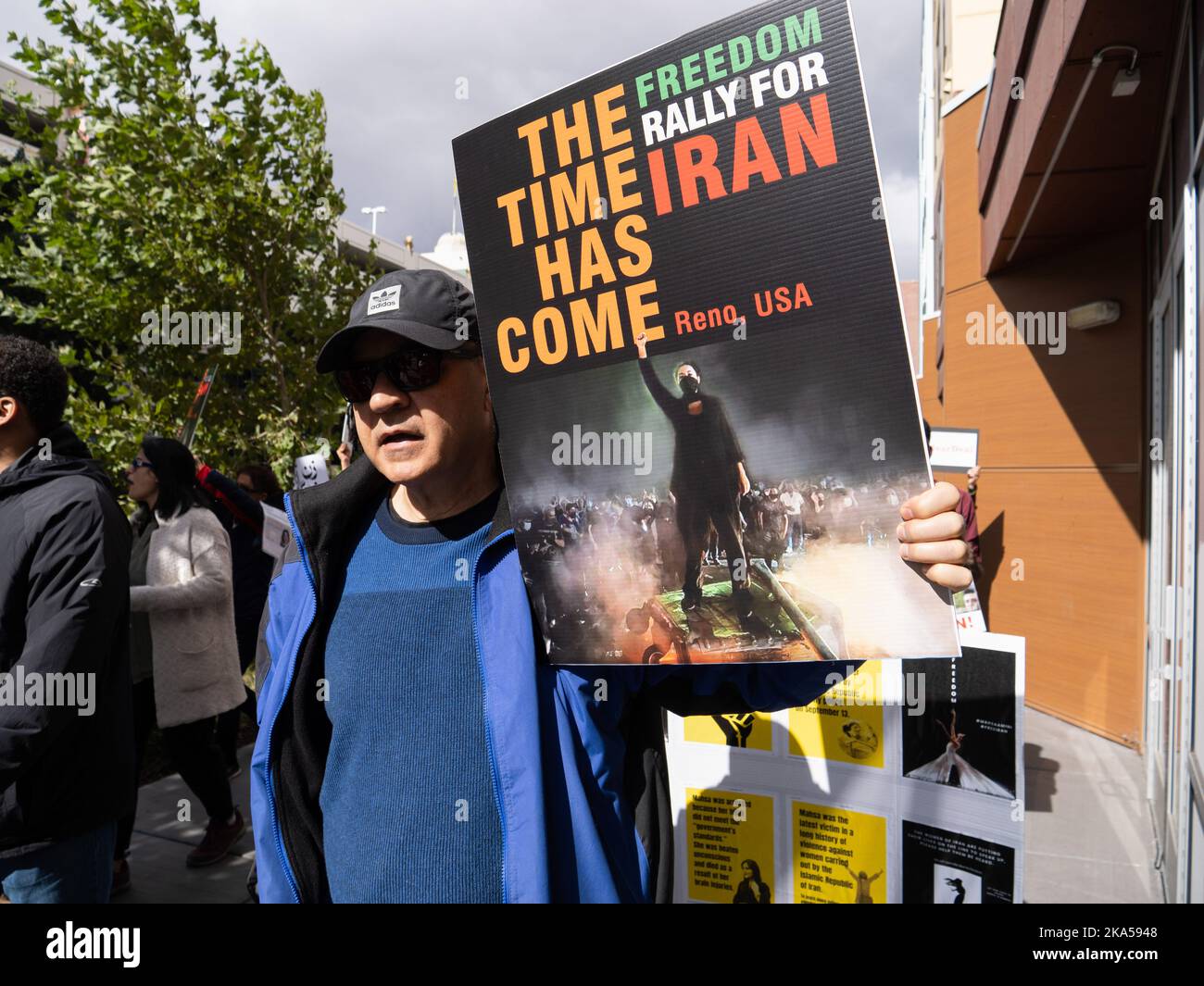 A protester carries a placard that says "The time has come, freedom ...