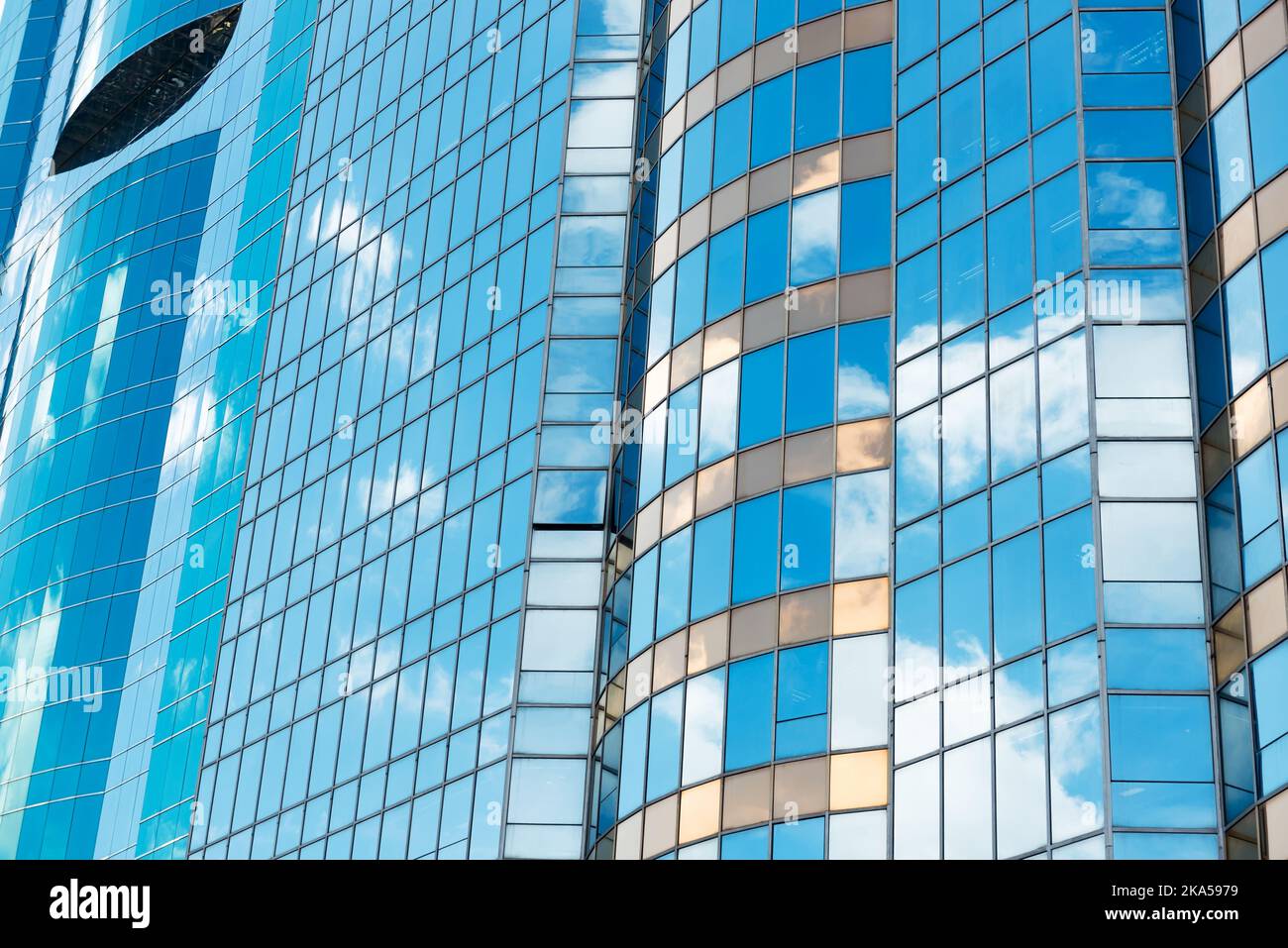 Cloudy sky reflected in the windows of skyscraper urban background hi ...