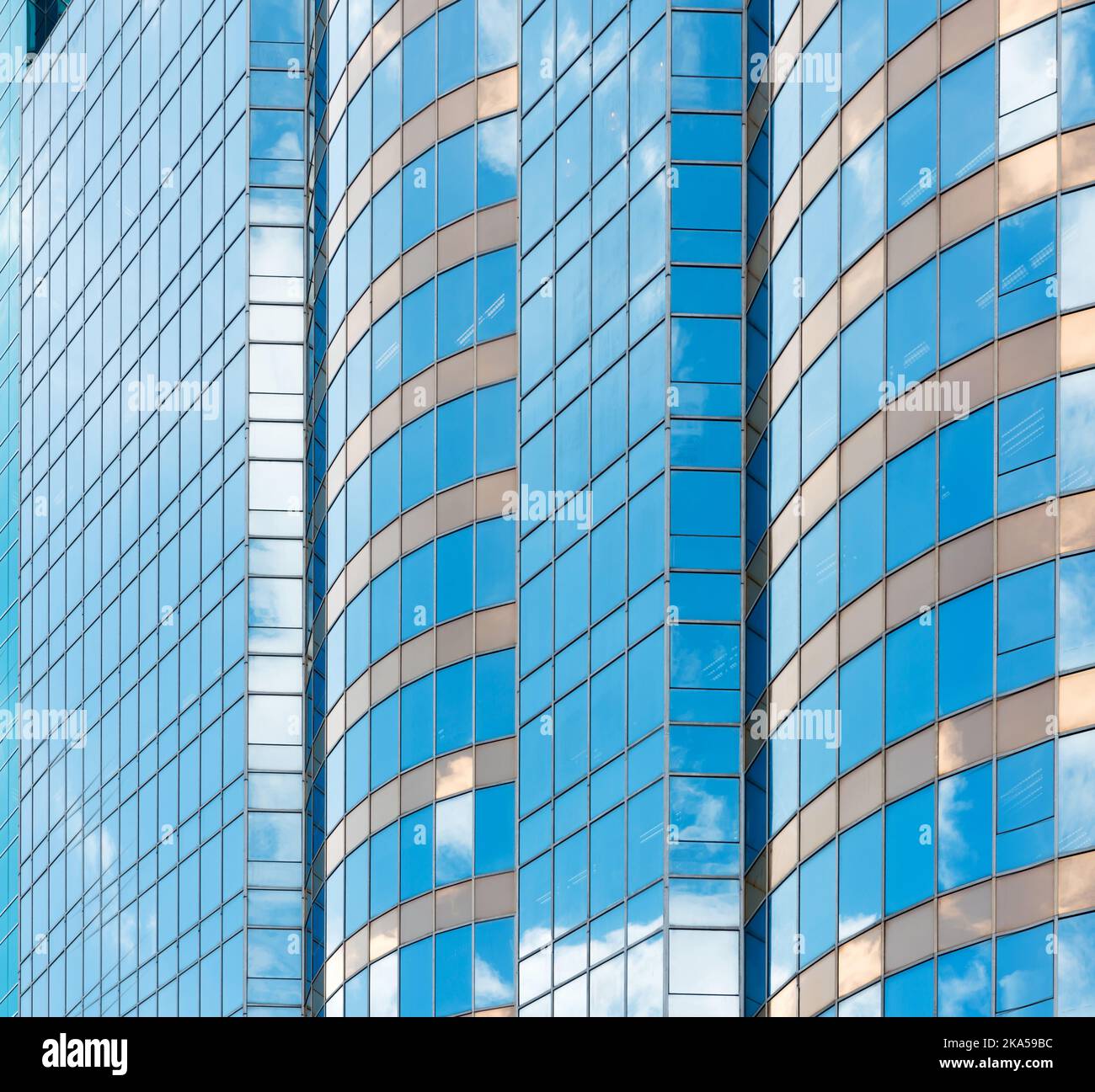 Cloudy sky reflected in the windows of skyscraper urban background hi ...