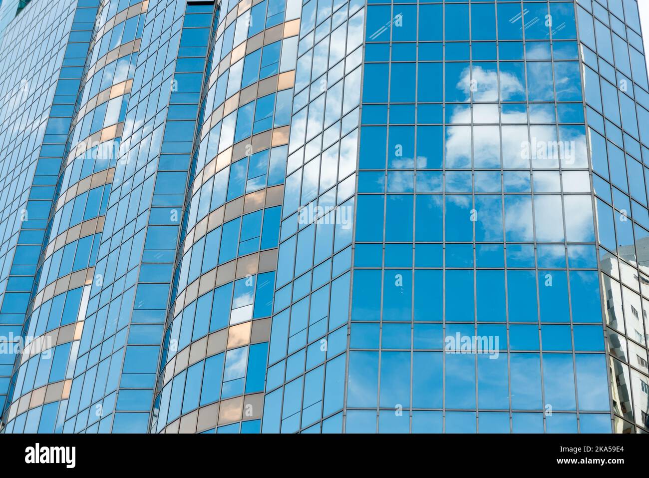 Cloudy sky reflected in the windows of skyscraper urban background hi ...