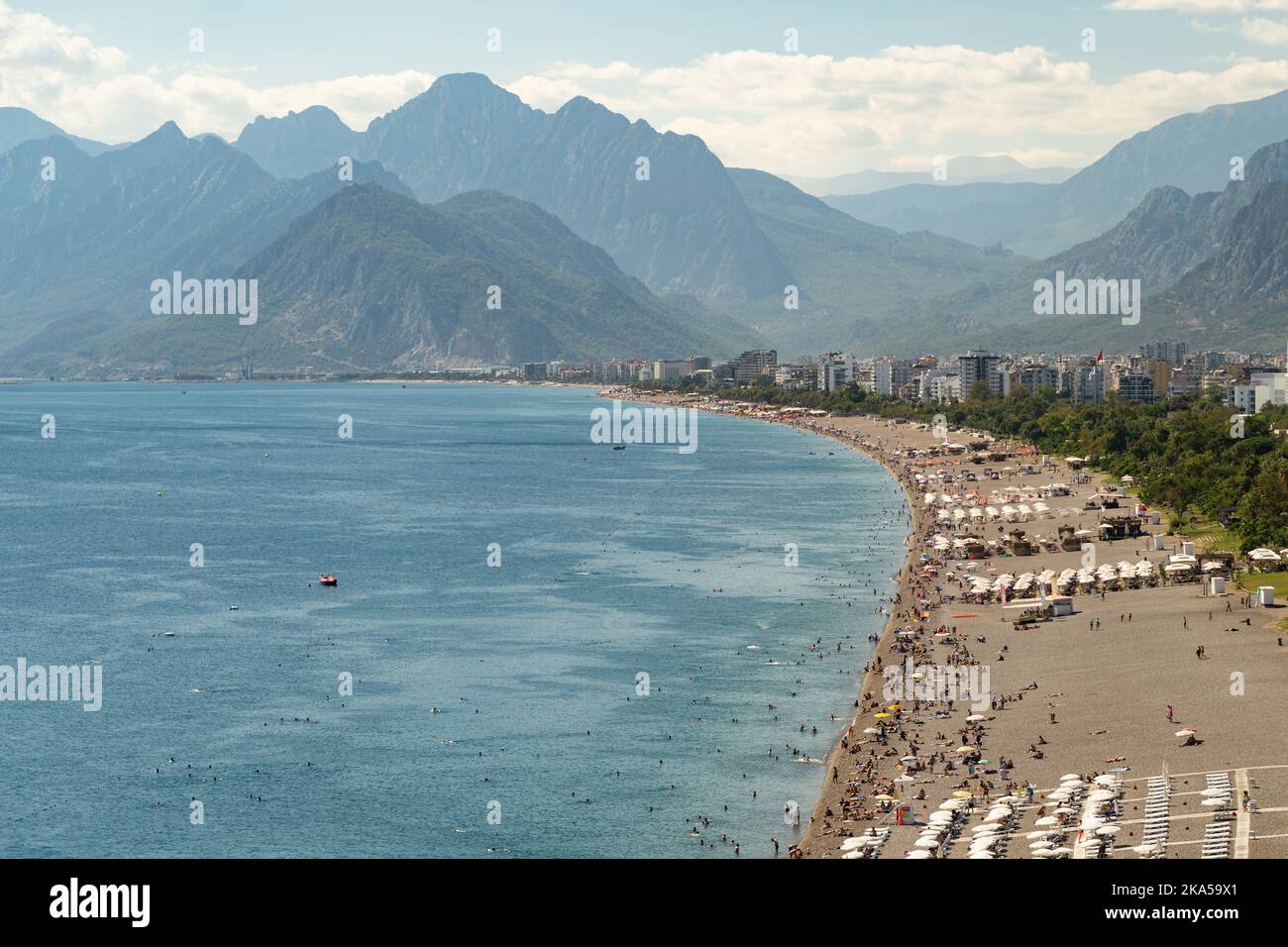 Sunny Turkey coast with people sunbathing on beaches of city of Antalya ...