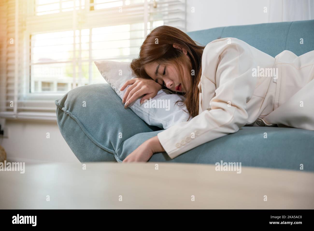 Tired woman sleeping closed eyes on sofa in living room at home Stock ...