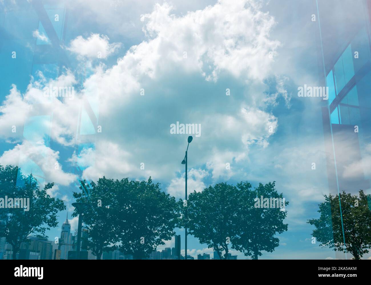 Clouds reflected in windows of modern office building Stock Photo - Alamy