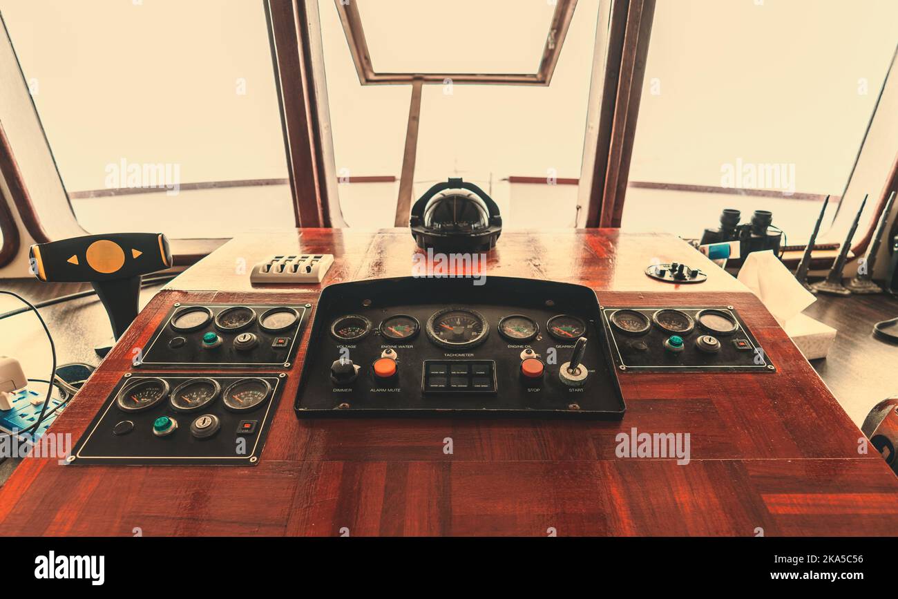 A wide-angle view of a vessel dashboard with multiple instruments, dial ...