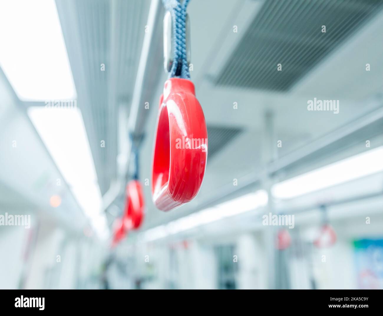 Handles for standing passenger inside a bus Stock Photo - Alamy