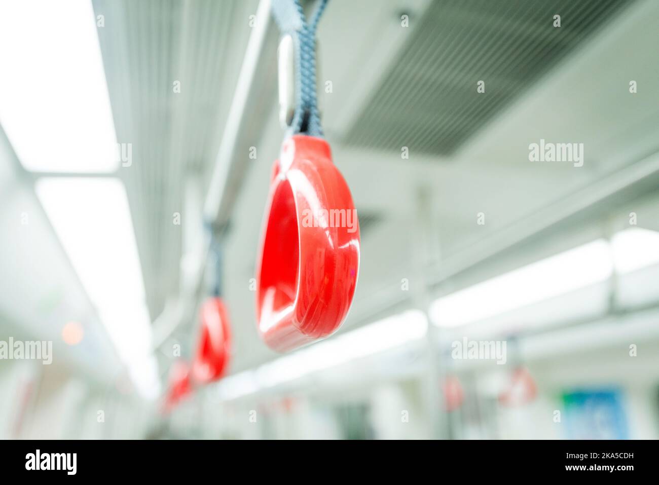 Handles for standing passenger inside a bus Stock Photo - Alamy