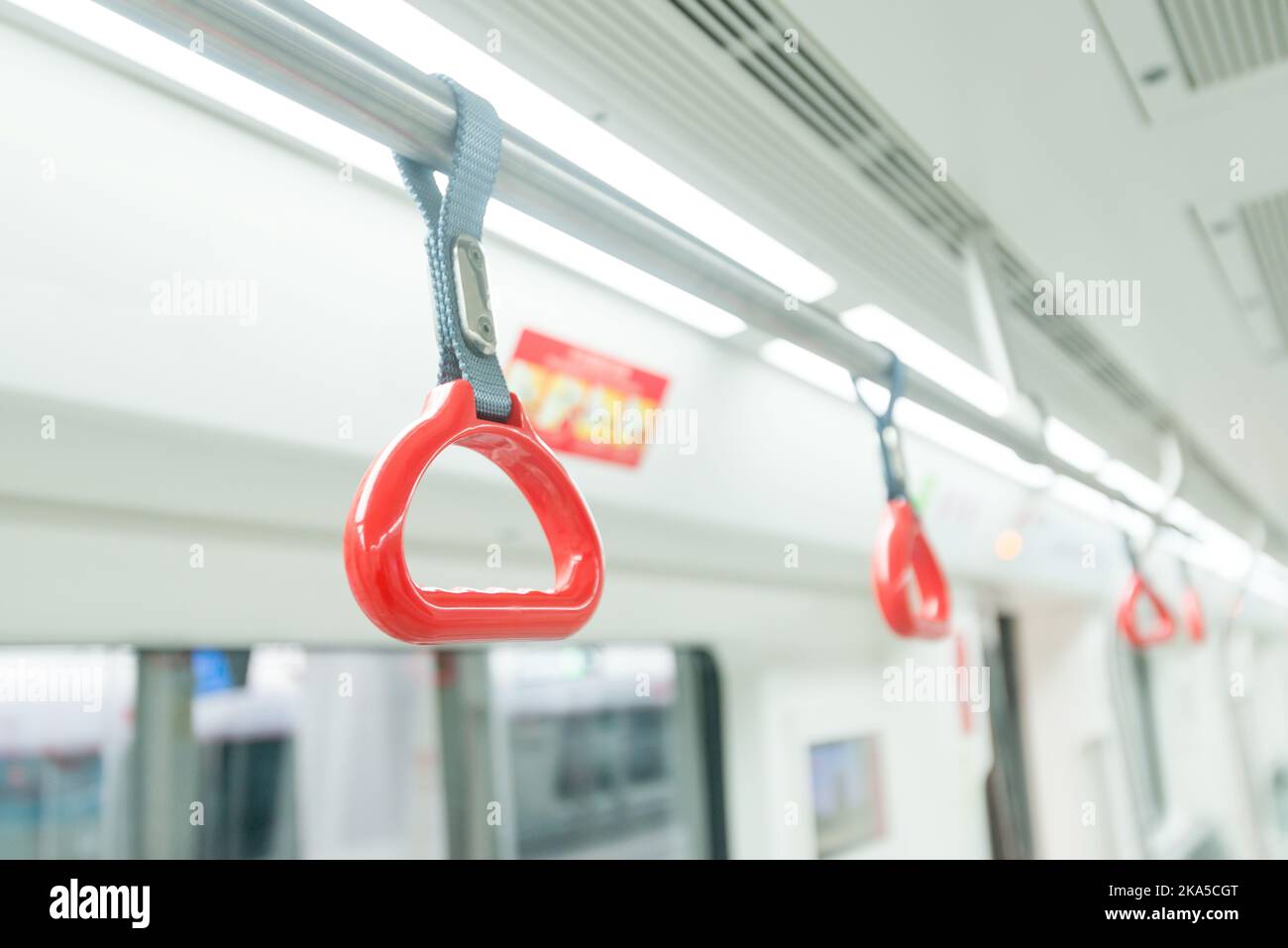 Handles for standing passenger inside a bus Stock Photo - Alamy