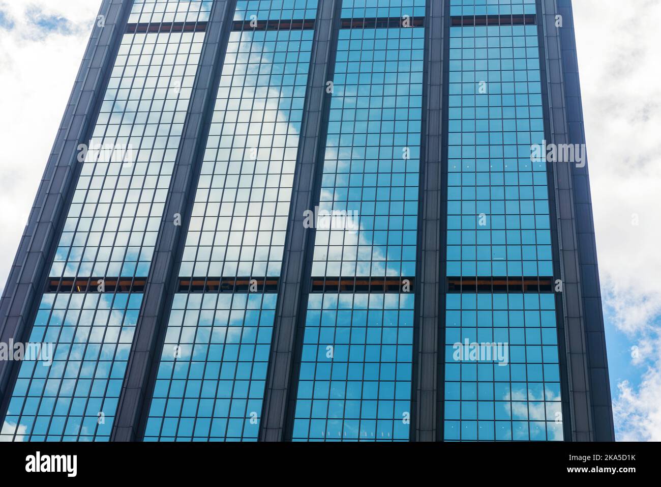 Cloudy sky reflected in the windows of skyscraper urban background hi ...