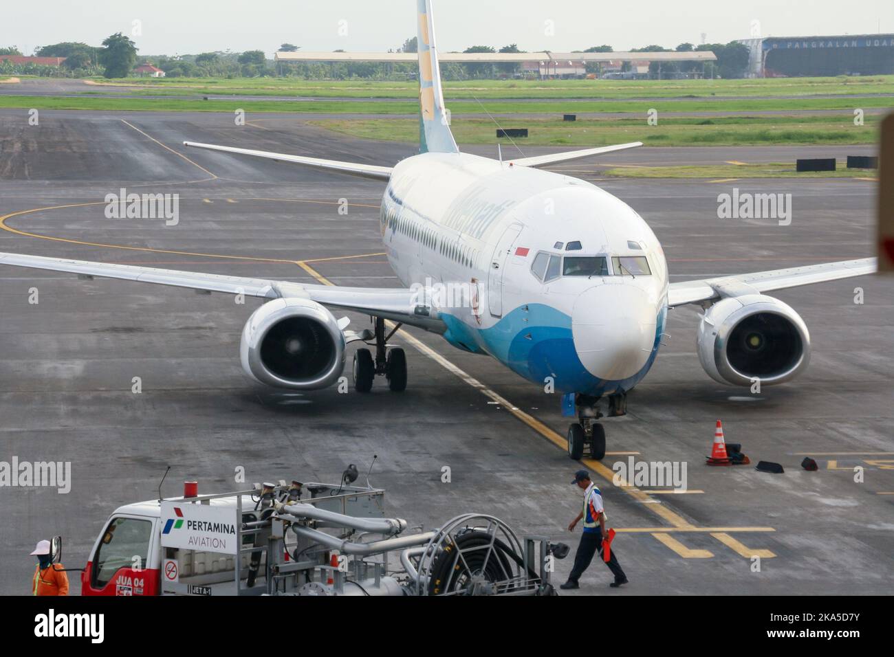 View of Merpati Airlines low cost carrier airliner on apron with ground ...