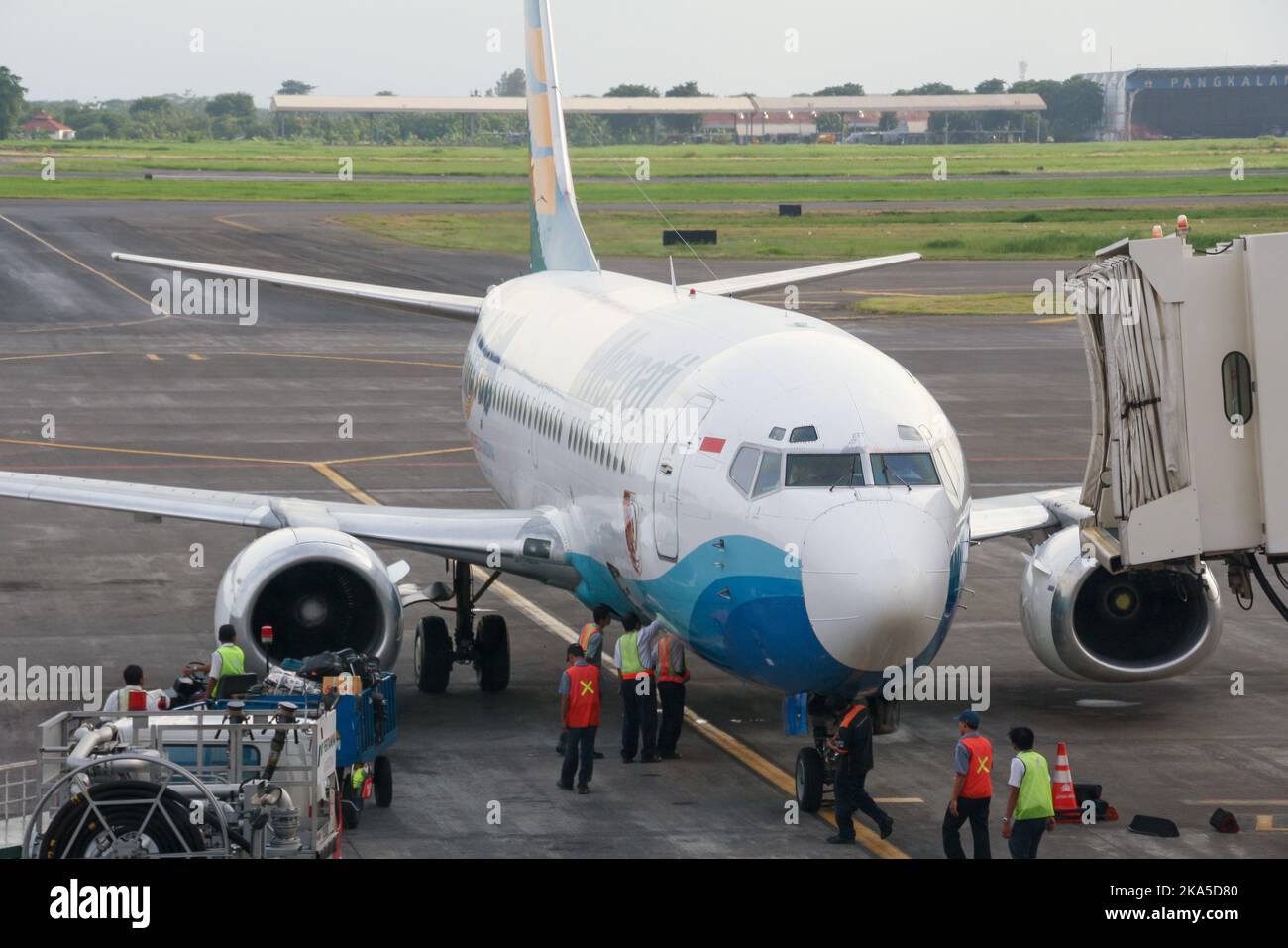 View of Merpati Airlines low cost carrier airliner on apron with ground ...