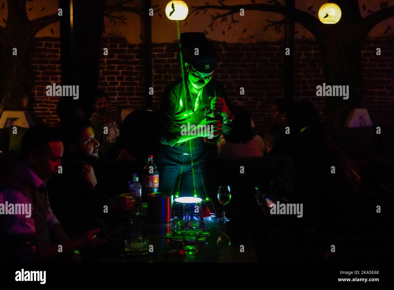 Kathmandu, Nepal. 31st Oct, 2022. A waiter donned in face paint serves ...