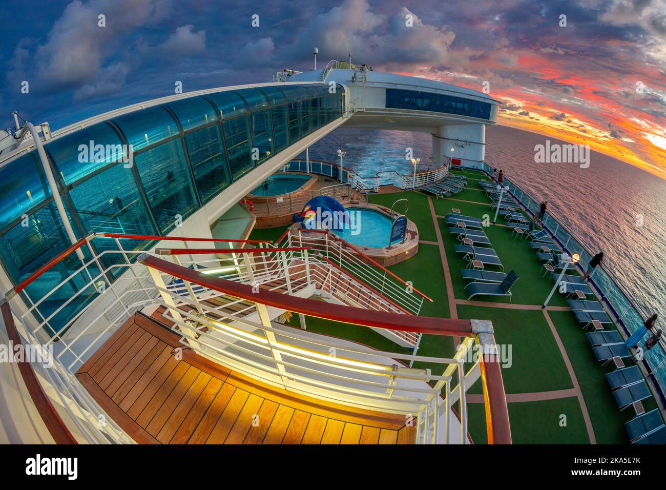 Wide angle view of entertainment deck on cruise liner at sunset with ...