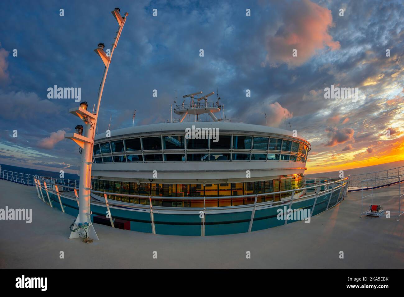 Wide angle view of observation deck on cruise liner at sunset with ...
