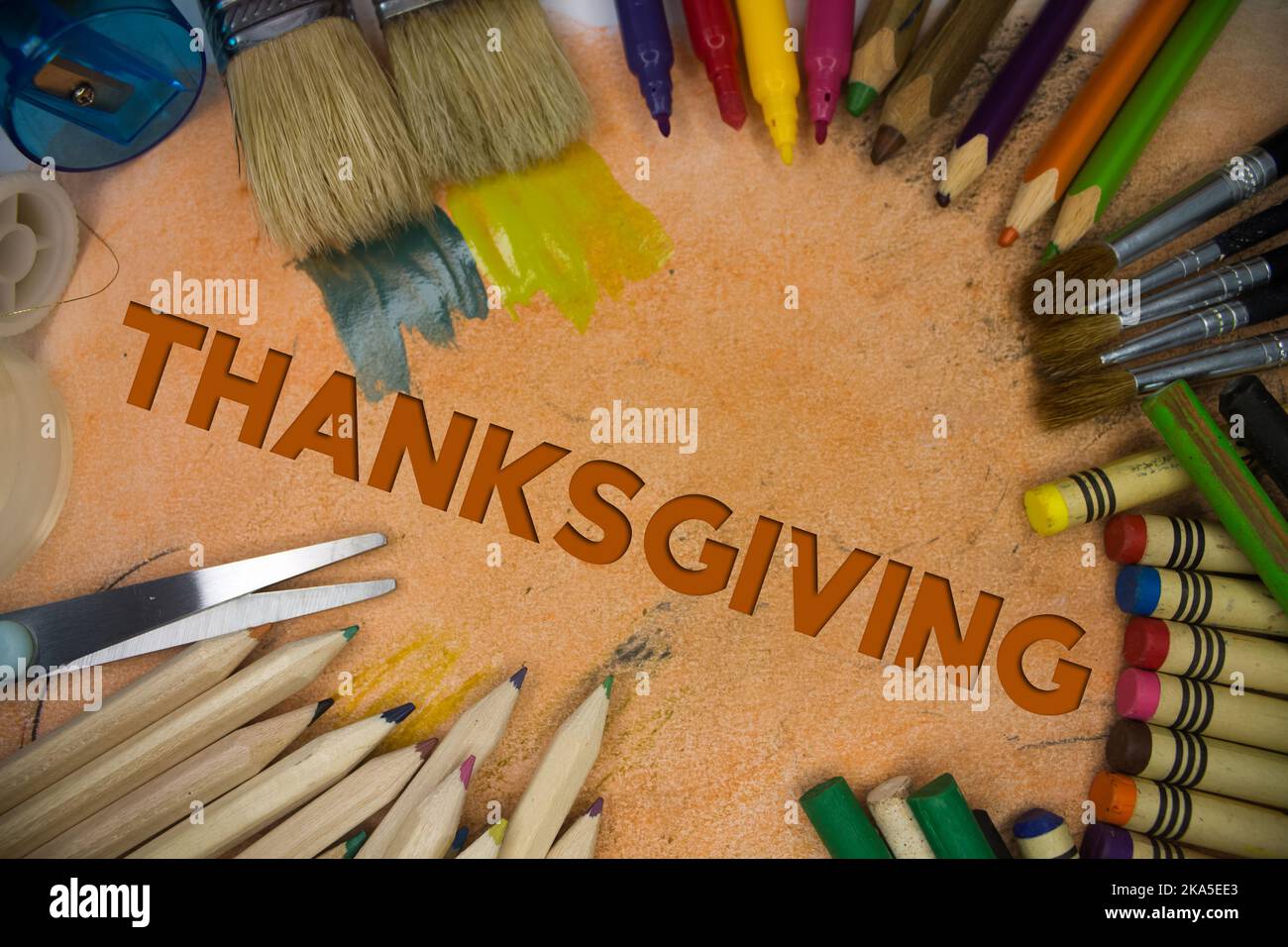 Overhead shot of school supplies with Thanksgiving text. Brushes ...