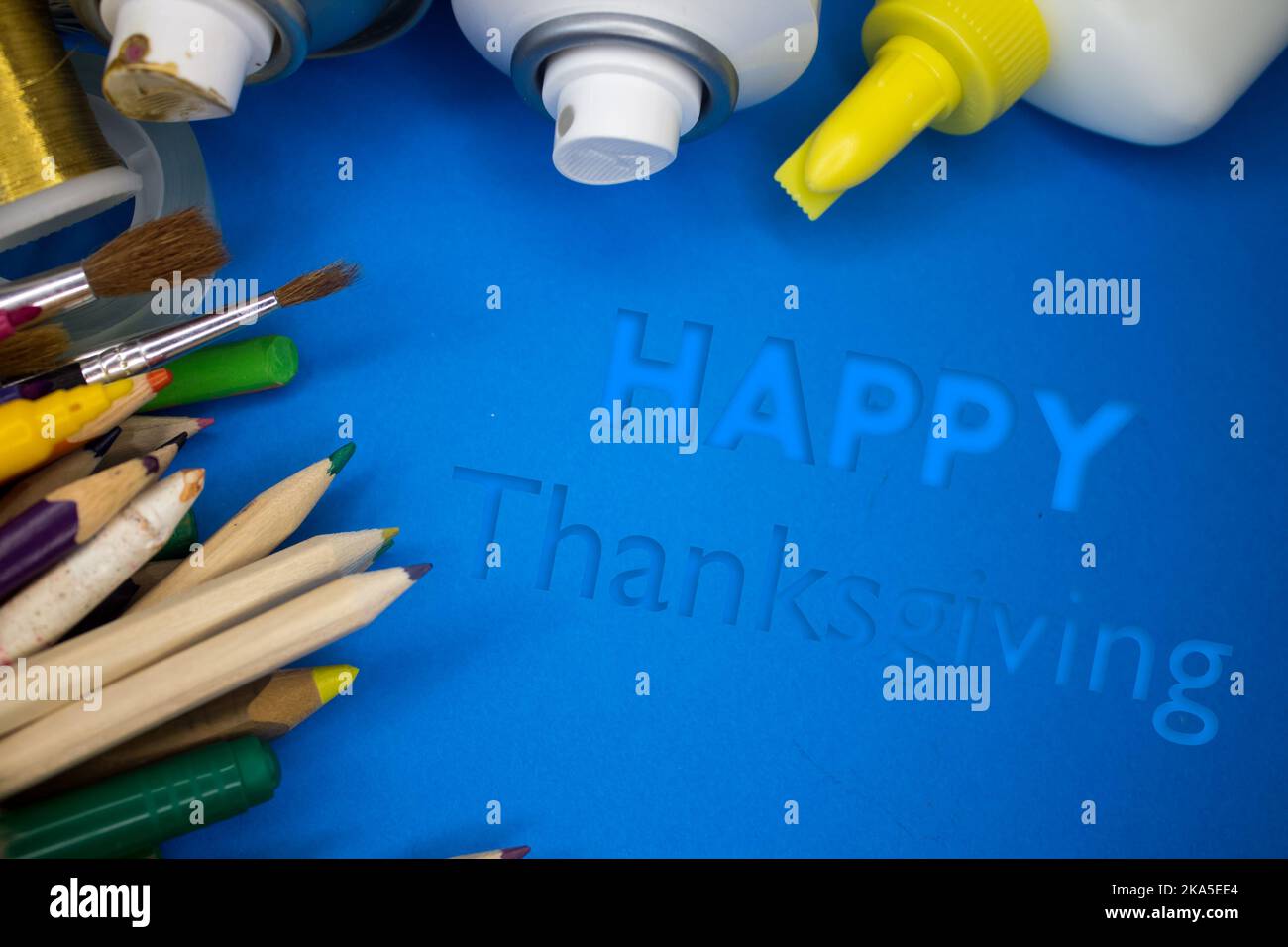 Overhead shot of school supplies with Thanksgiving text. Brushes ...
