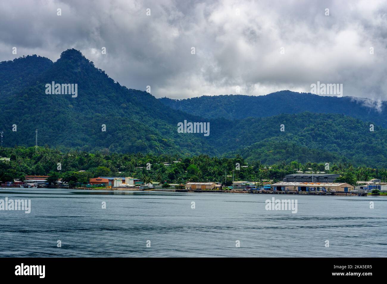 Alotau harbour at the foothills of the jungle covered Owen Stanley ...