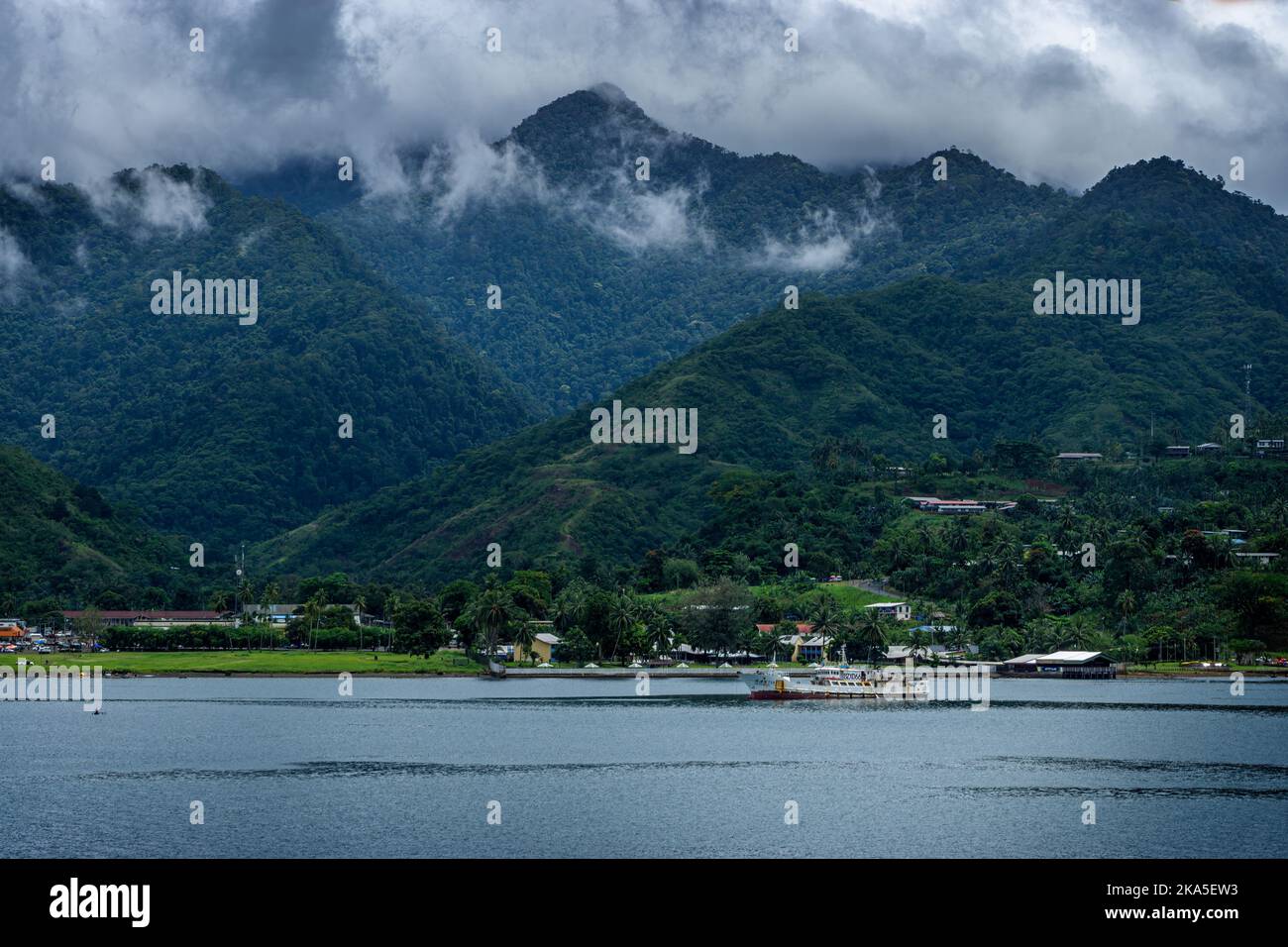 Alotau harbour at the foothills of the jungle covered Owen Stanley ...