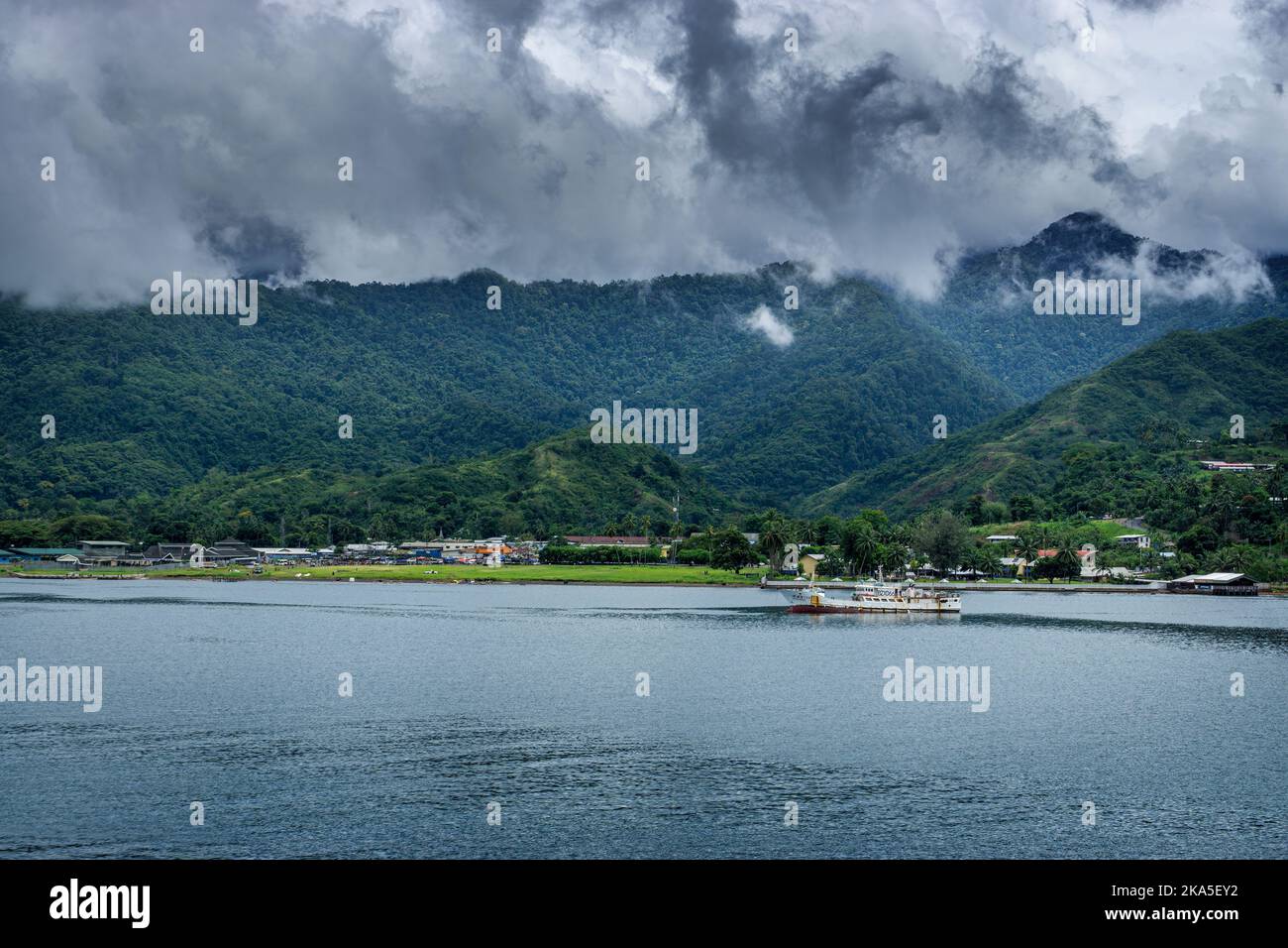 Alotau harbour at the foothills of the jungle covered Owen Stanley ...