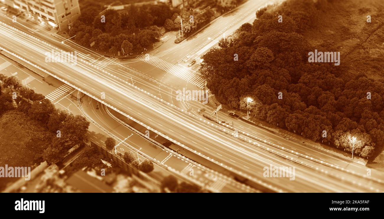High-speed vehicles bright light trails on urban roads under the ...