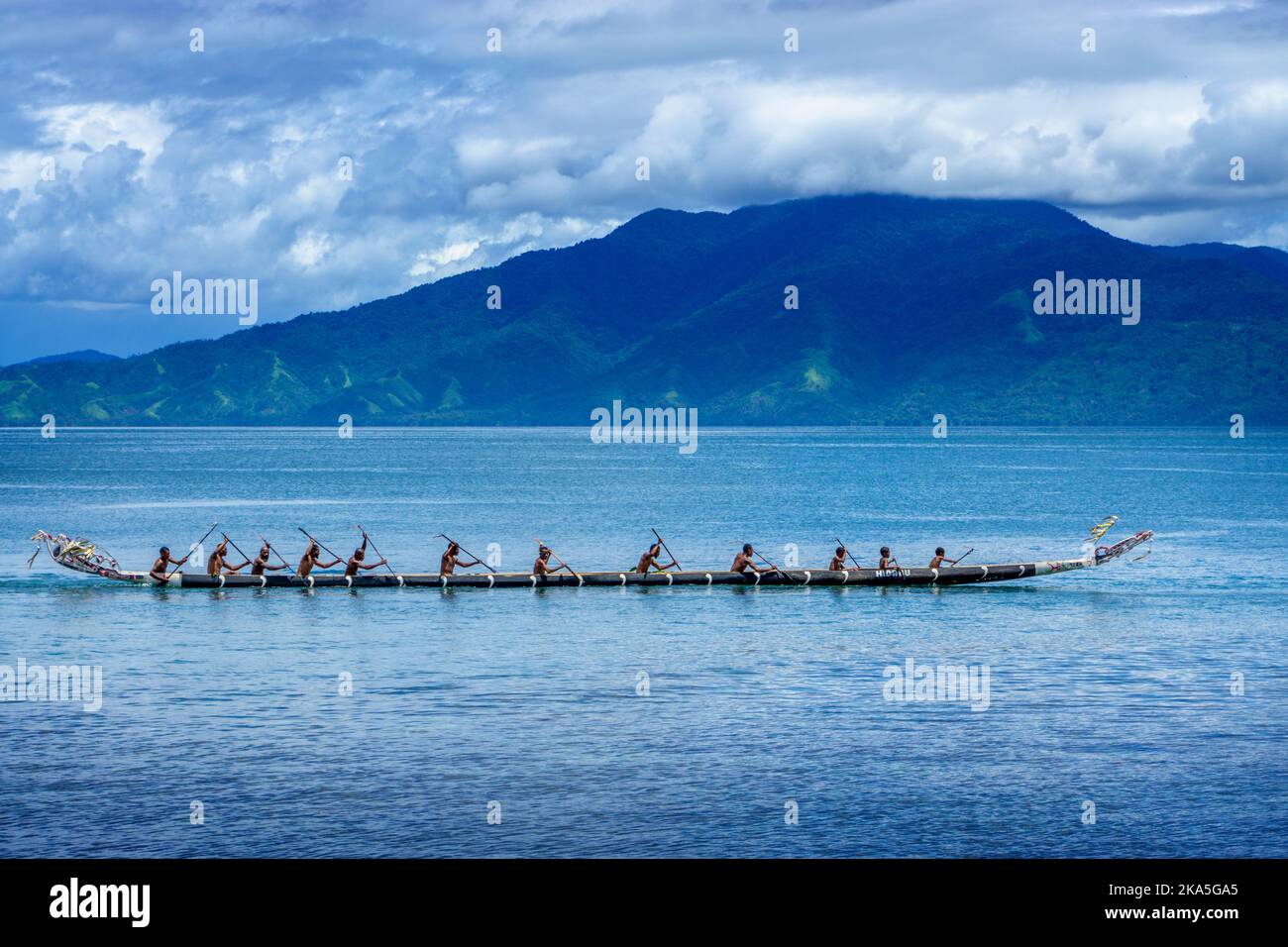 Indigenous paddlers in traditional costume demonstrating paddling ...