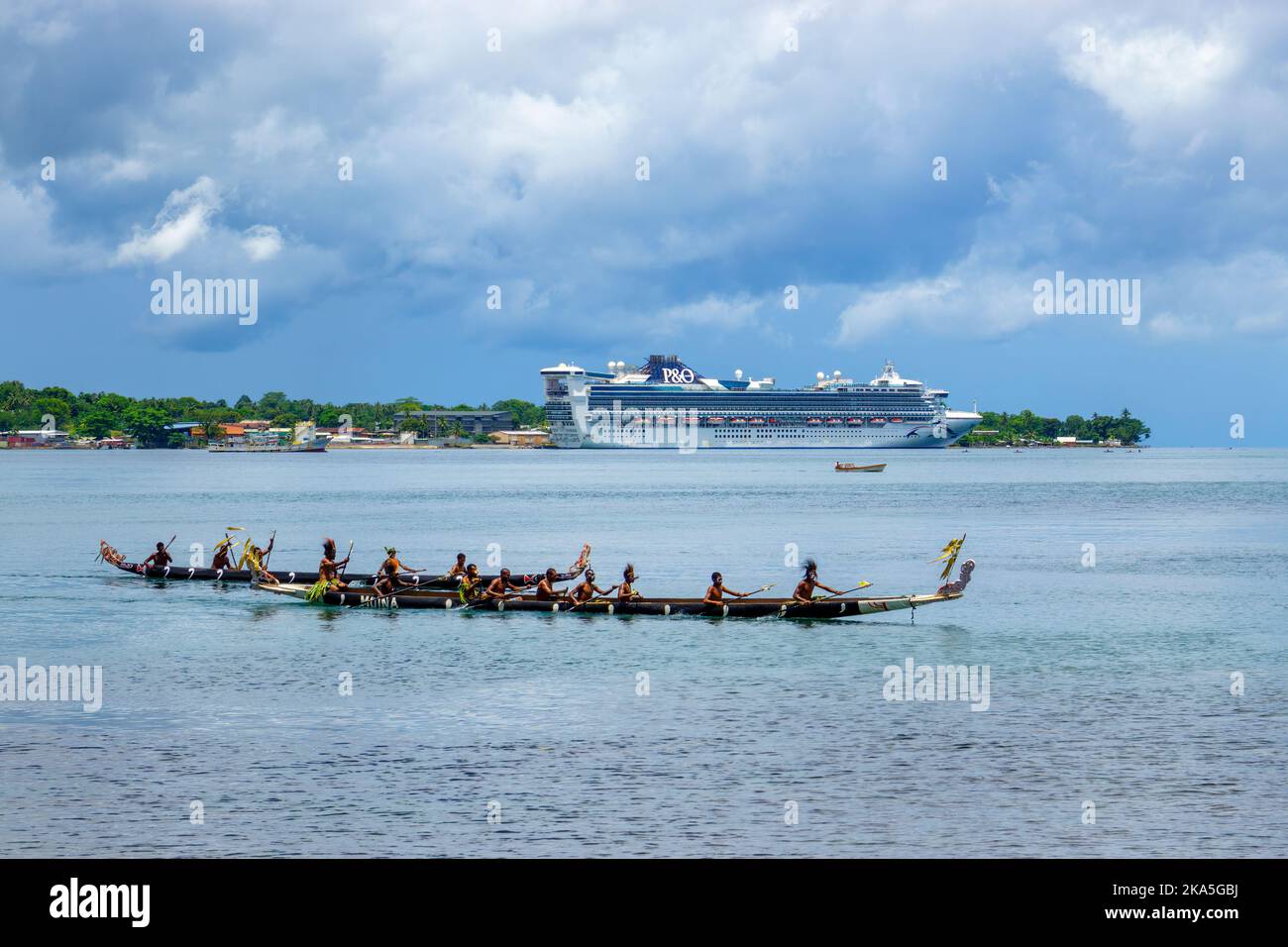 Indigenous paddlers in traditional costume demonstrating paddling ...
