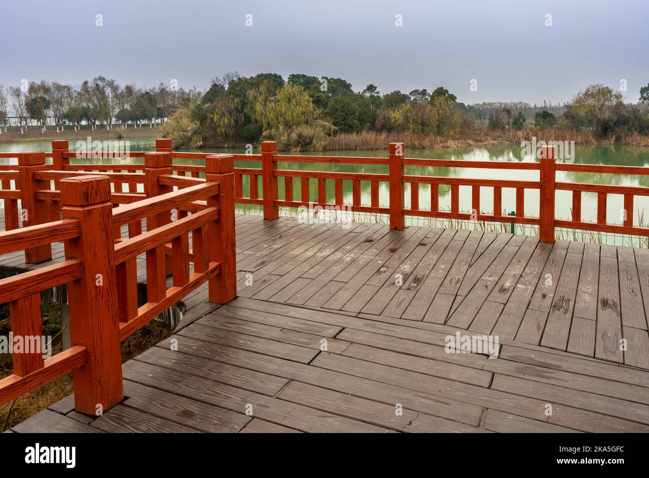 Wooden bridge over little river in city park Stock Photo - Alamy