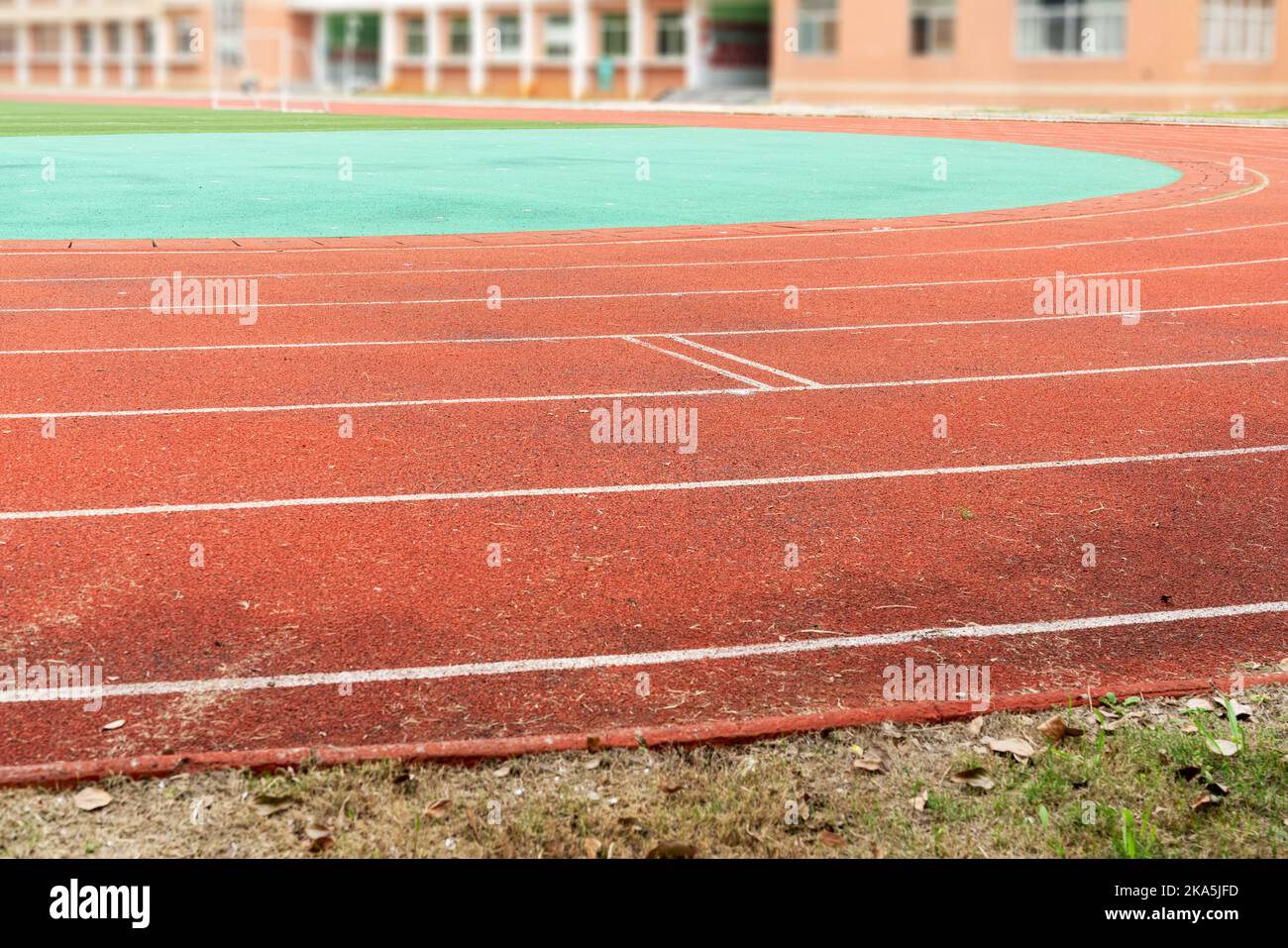 Red running track in stadium Stock Photo - Alamy