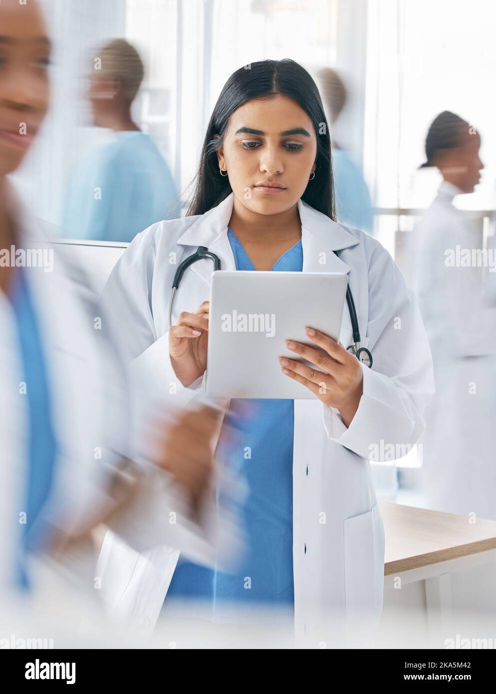 Doctor, tablet and busy hospital with internet research, online ...