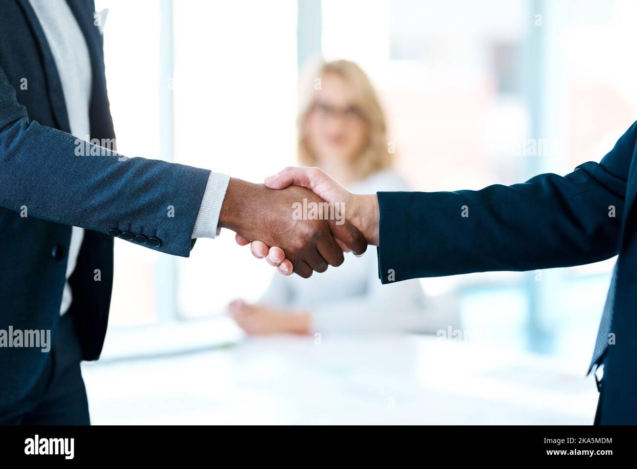 Two businessmen shaking hands partnering hi-res stock photography and ...