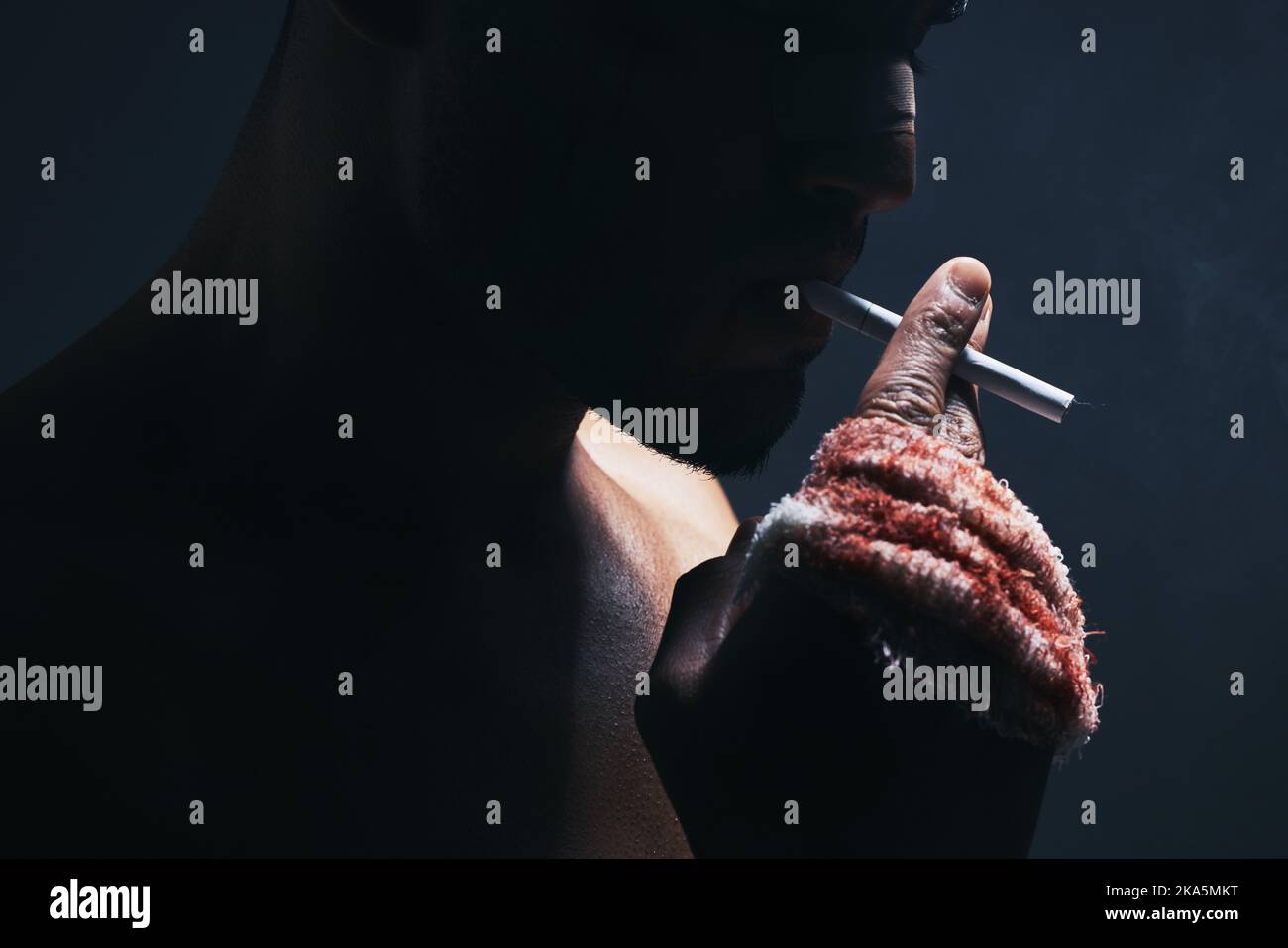 Injury, cigarette and blood bandage on hand of kickboxing man in studio ...