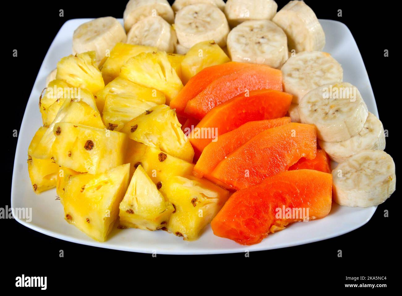 Tropical fruits on the plate cut into cubes, fresh exotic fruit plate ...