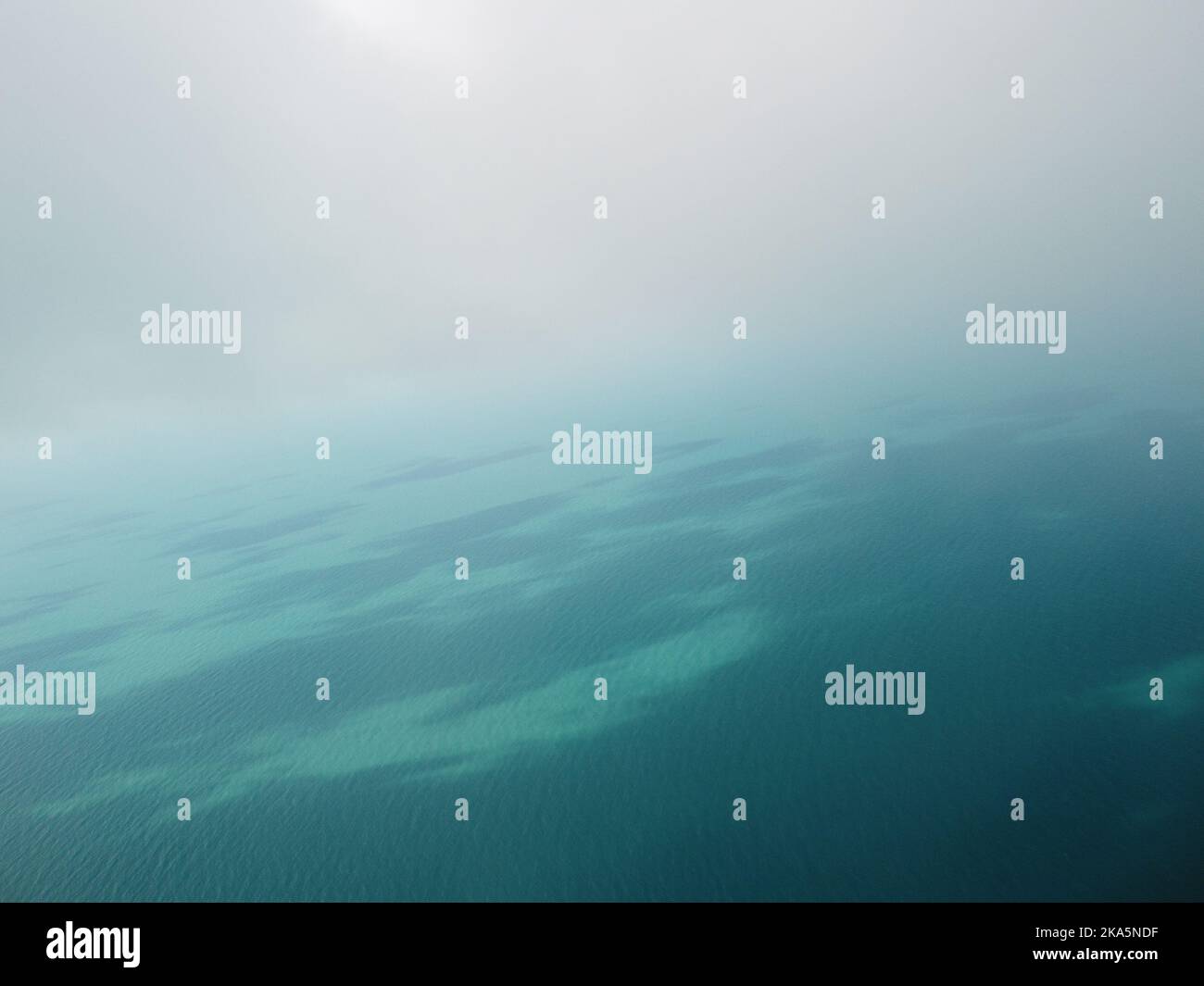 Aerial view from above on calm azure sea and volcanic rocky shores ...