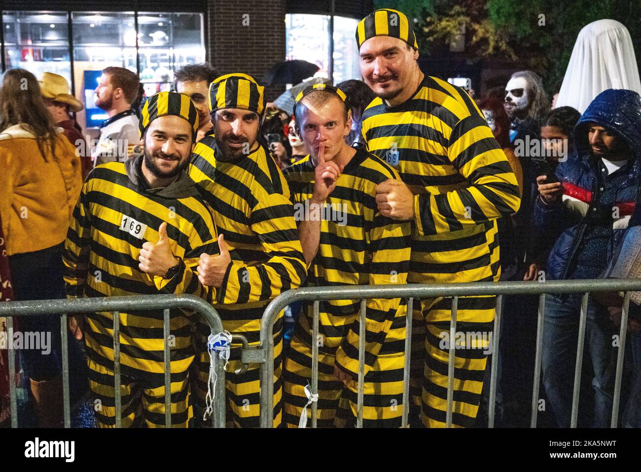 New York, USA. 31st Oct, 2022. People wear prisoner costumes as they ...