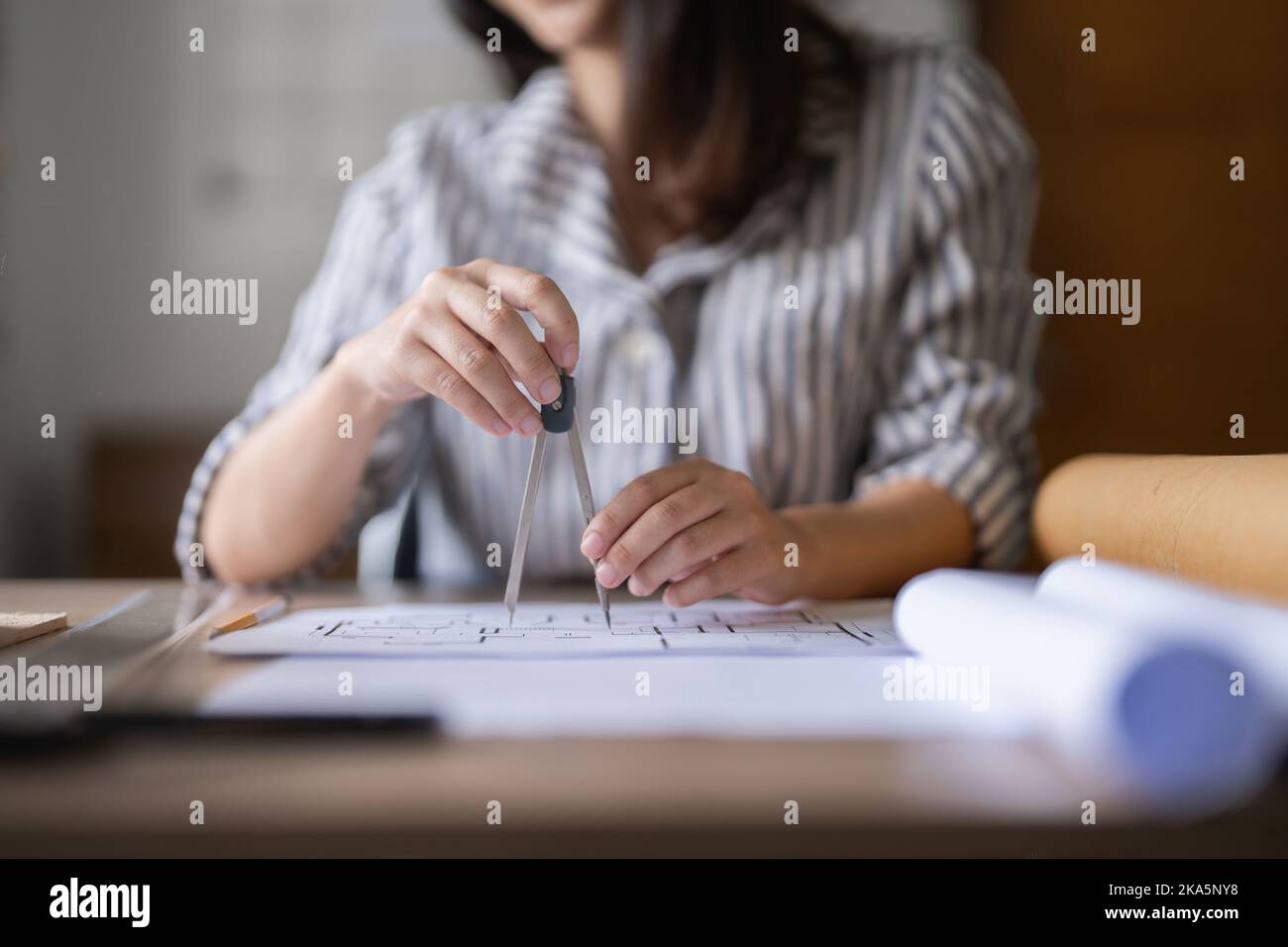 Architect woman working with blueprints for architectural plan ...