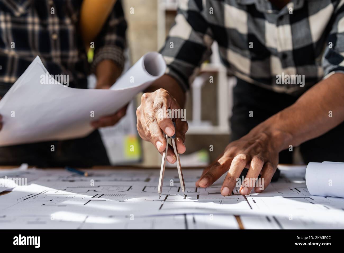 Architect team working with blueprints for architectural plan, engineer ...