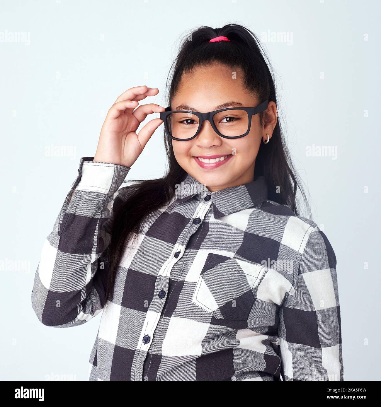 Check out my cool specs. Studio portrait of a cute and confident young ...