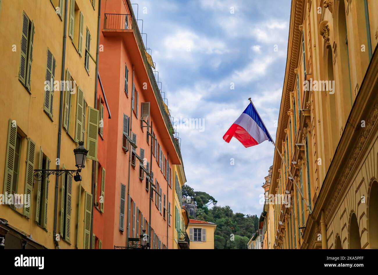 Colorful traditional houses with the French Republic tricolor flag in ...